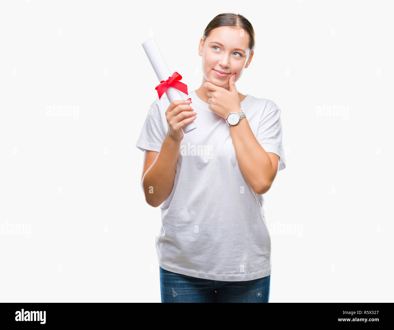 Young caucasian woman holding degree over isolated background serious ...