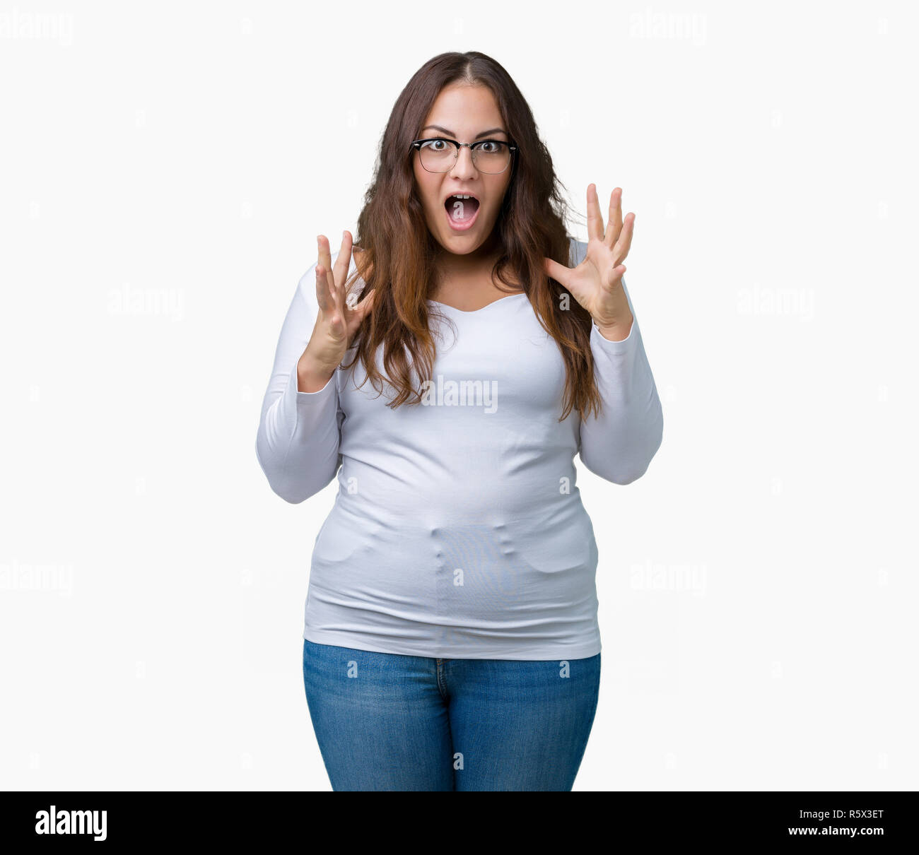 Beautiful plus size young woman over isolated background crazy and mad ...