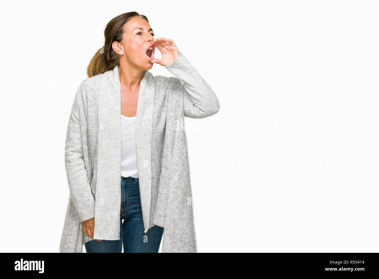 Beautiful middle age adult woman wearing winter sweater over isolated ...