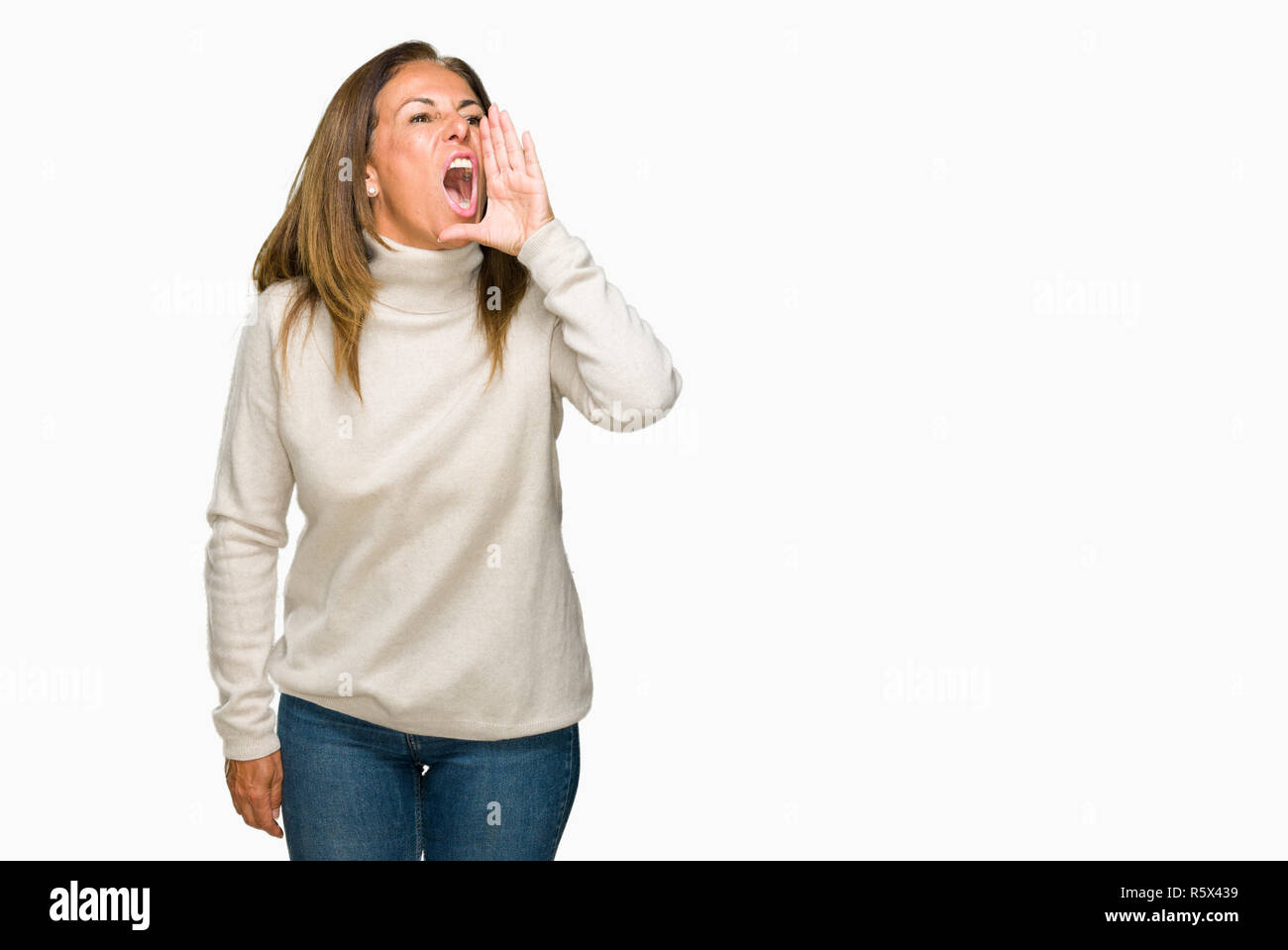 Beautiful middle age adult woman wearing winter sweater over isolated ...