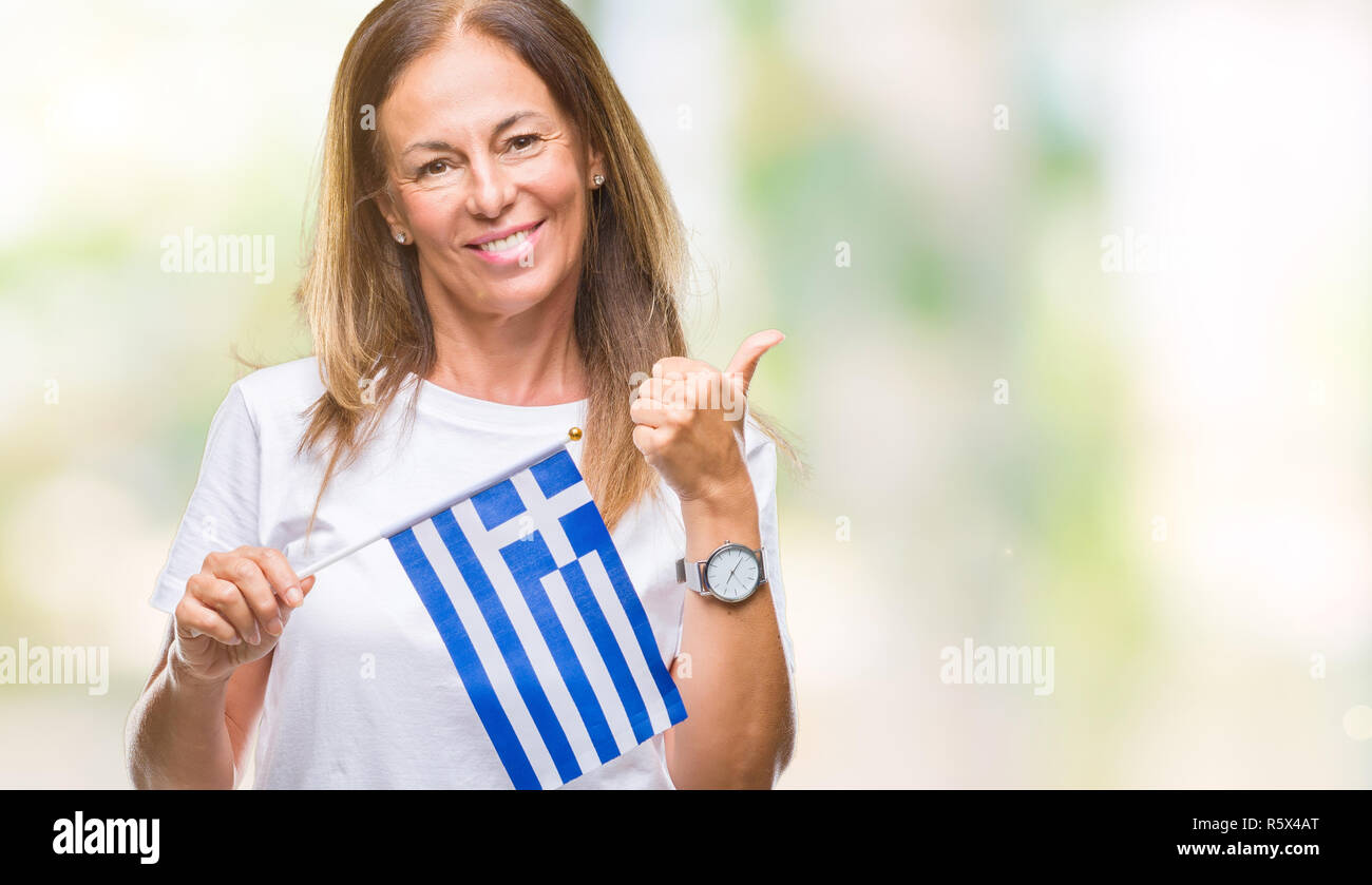 Middle age hispanic woman holding flag of Greece over isolated ...