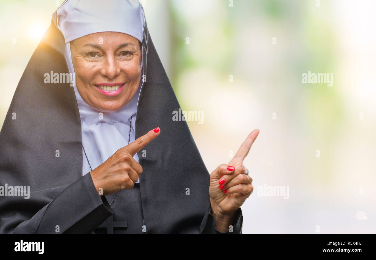 Middle age senior christian catholic nun woman over isolated background ...