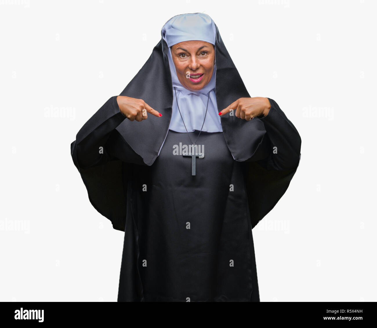 Middle age senior christian catholic nun woman over isolated background ...
