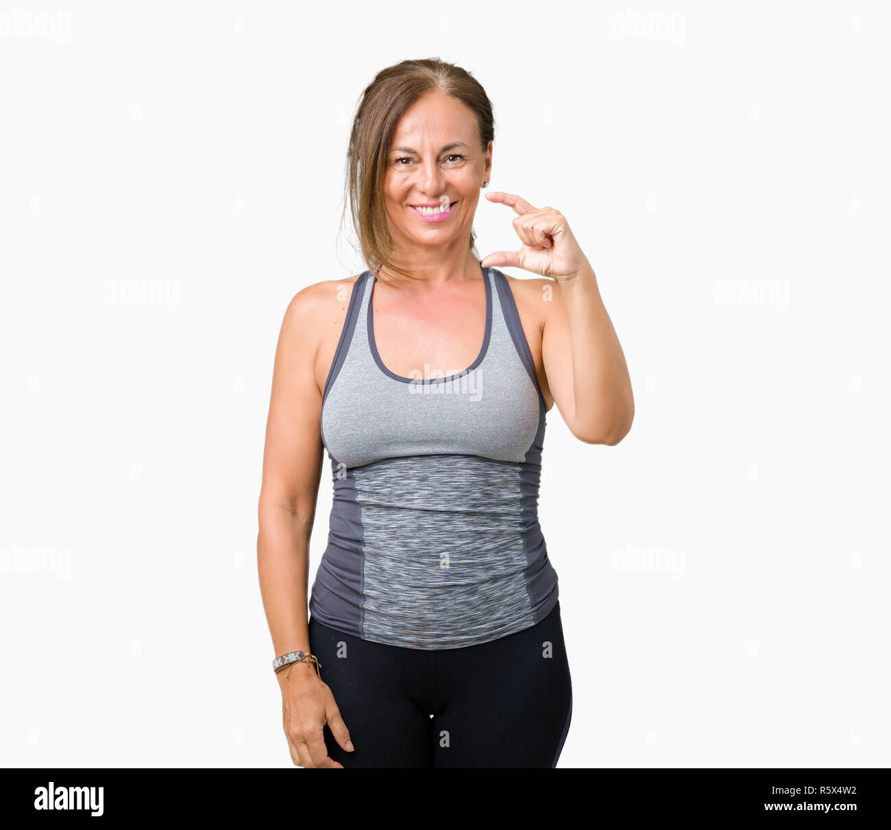 Beautiful middle age woman wearing sport clothes over isolated ...