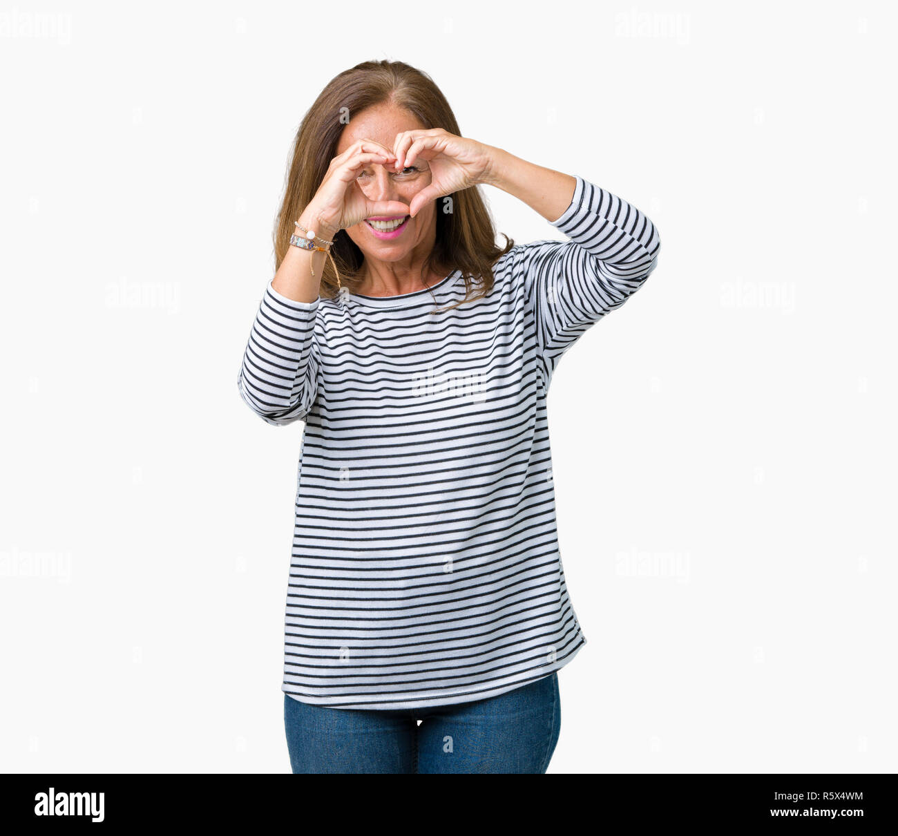 Beautiful middle age woman wearing stripes sweater over isolated ...