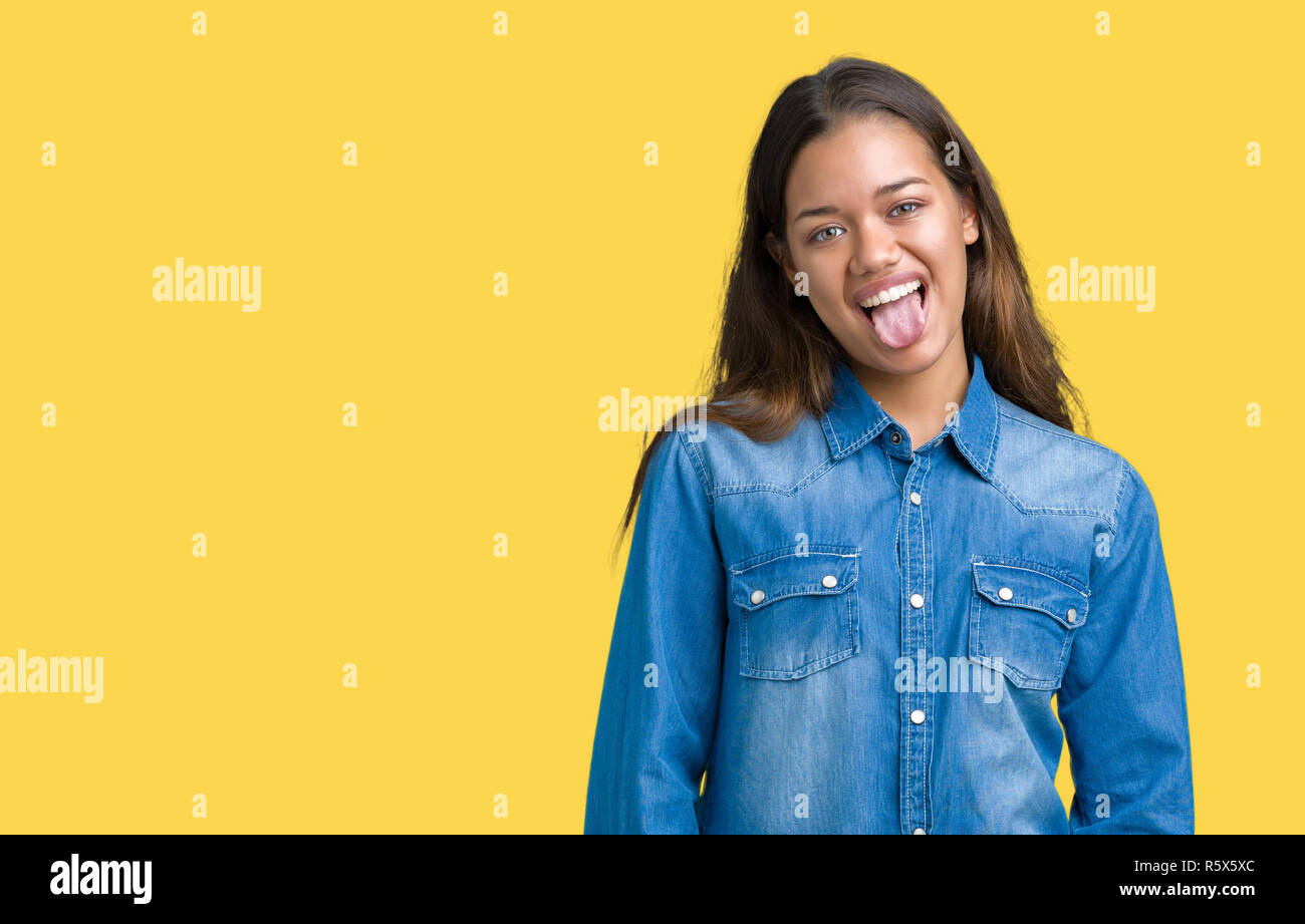 Young beautiful brunette woman wearing blue denim shirt over isolated ...