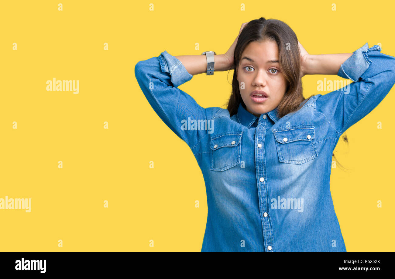 Young beautiful brunette woman wearing blue denim shirt over isolated ...