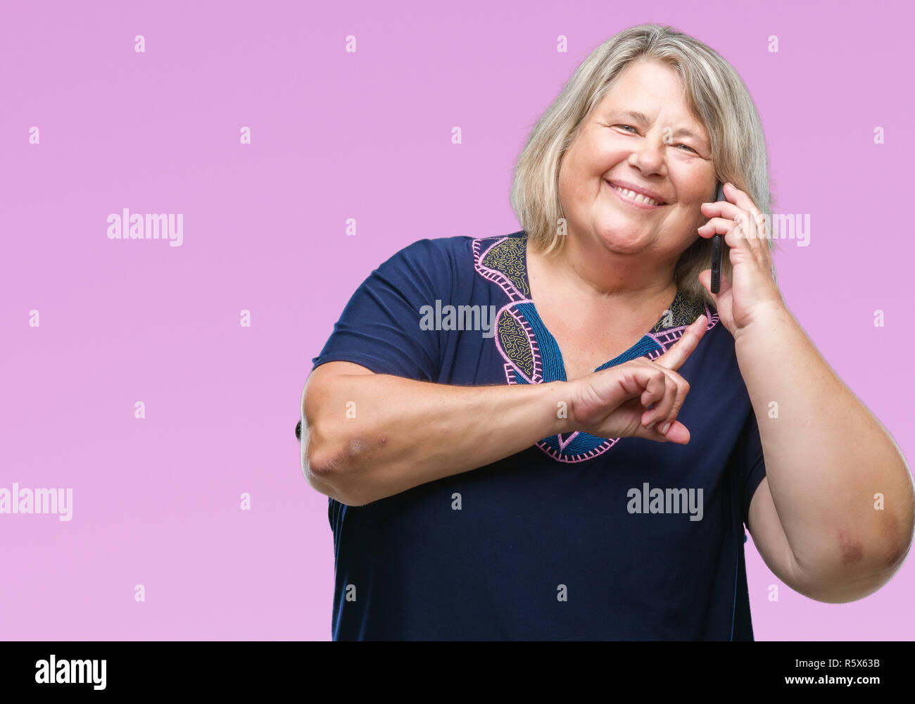 Senior plus size caucasian woman talking on the phone over isolated ...