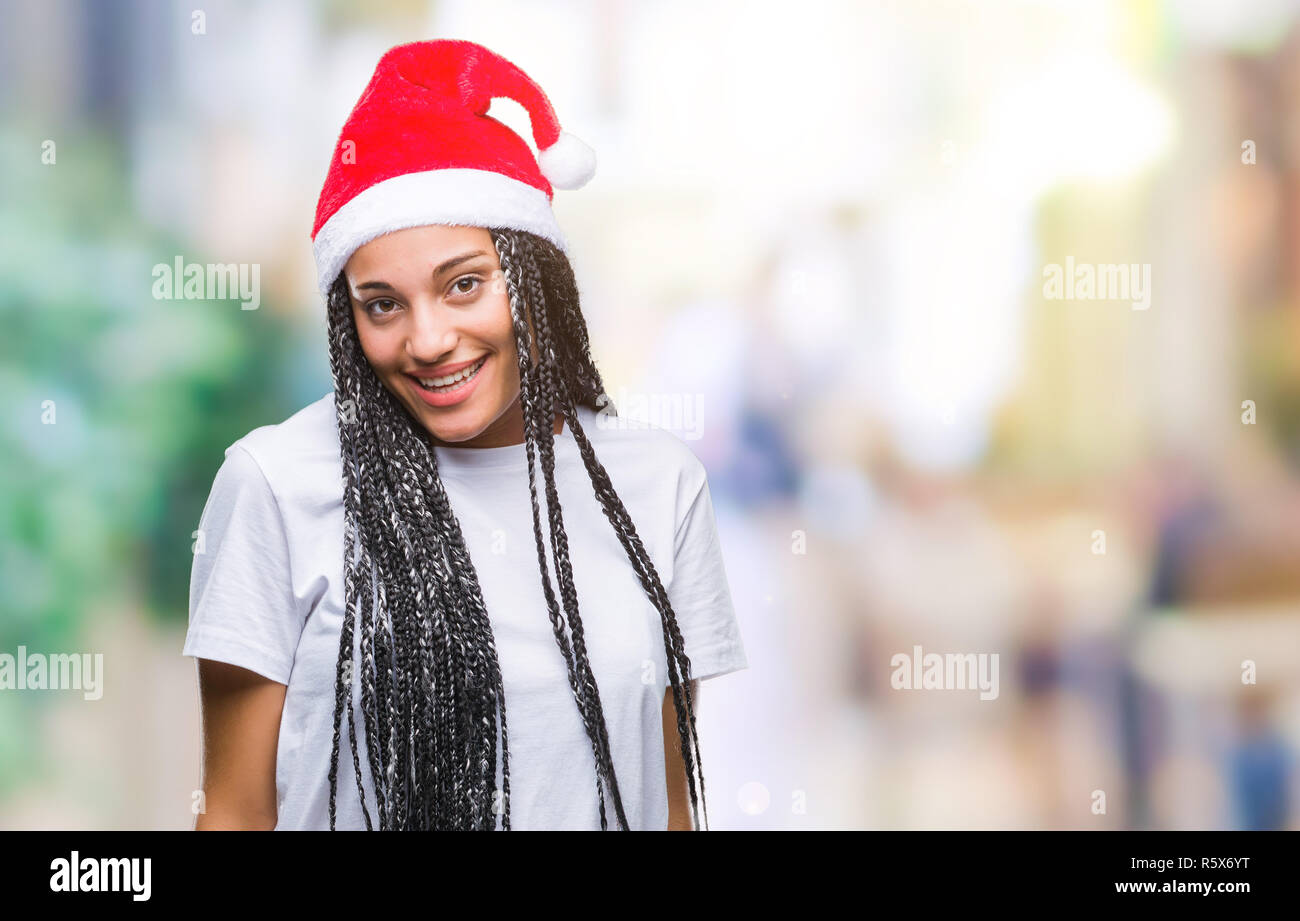 Young braided hair african american girl wearing christmas hat over ...