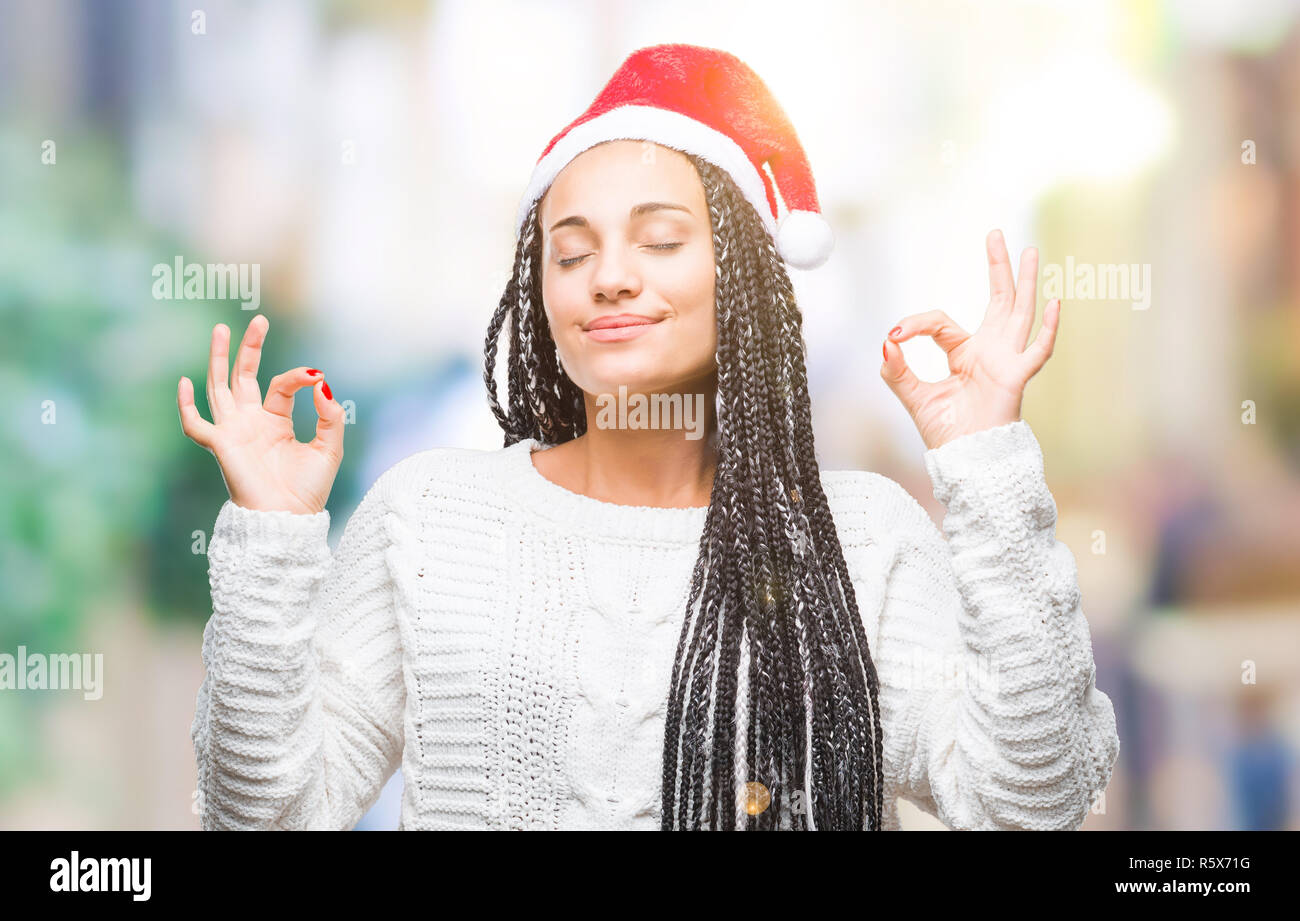 Young braided hair african american girl wearing christmas hat over ...
