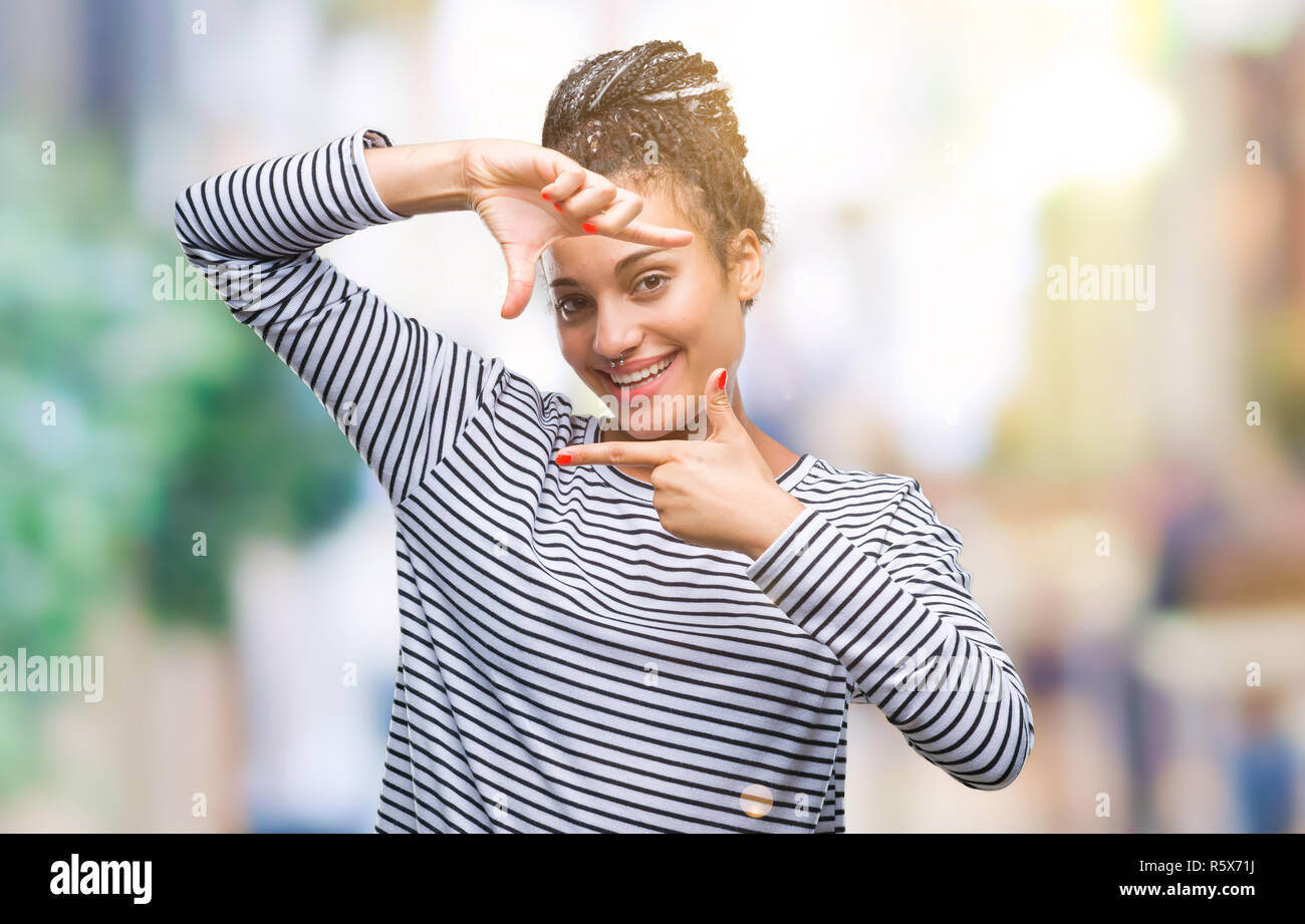 Young braided hair african american girl wearing sweater over isolated ...