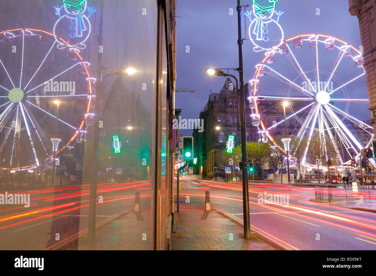 Reflections through a window, of the big wheel tourist attraction in ...