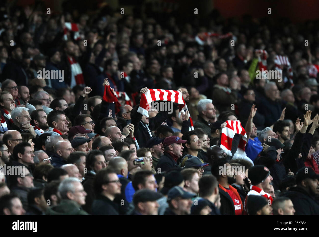 London, UK. 2nd Dec, 2018. An Arsenal fan holds his flag aloft at the ...