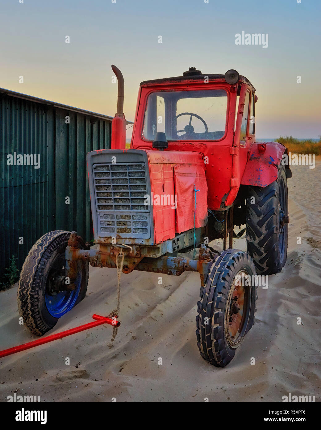 Big red tractor on the beach in Ahlbeck. Germany Stock Photo - Alamy