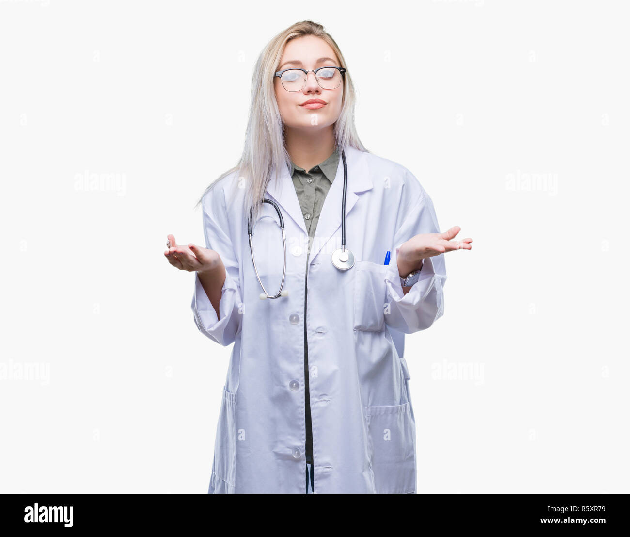 Young blonde doctor woman over isolated background clueless and ...