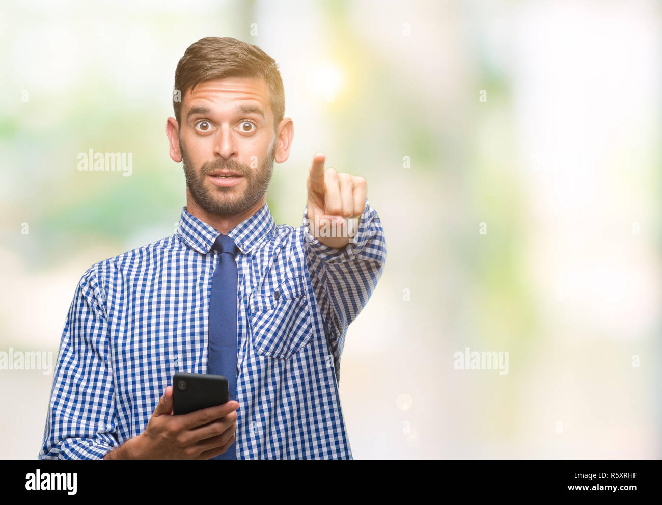 Young hadsome man texting sending message using smartphone over ...