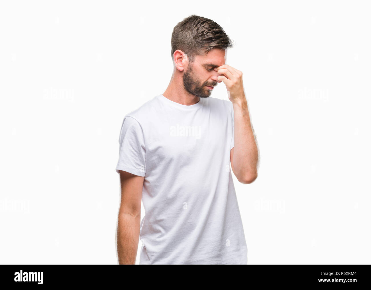 Young handsome man over isolated background tired rubbing nose and eyes ...