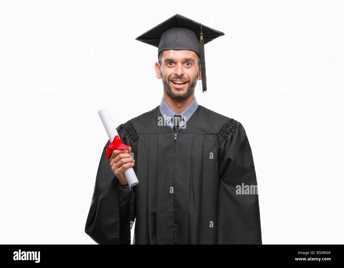 Young handsome graduated man holding degree over isolated background ...