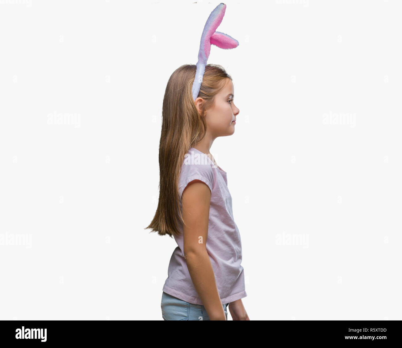 Young beautiful girl wearing easter bunny ears over isolated background ...