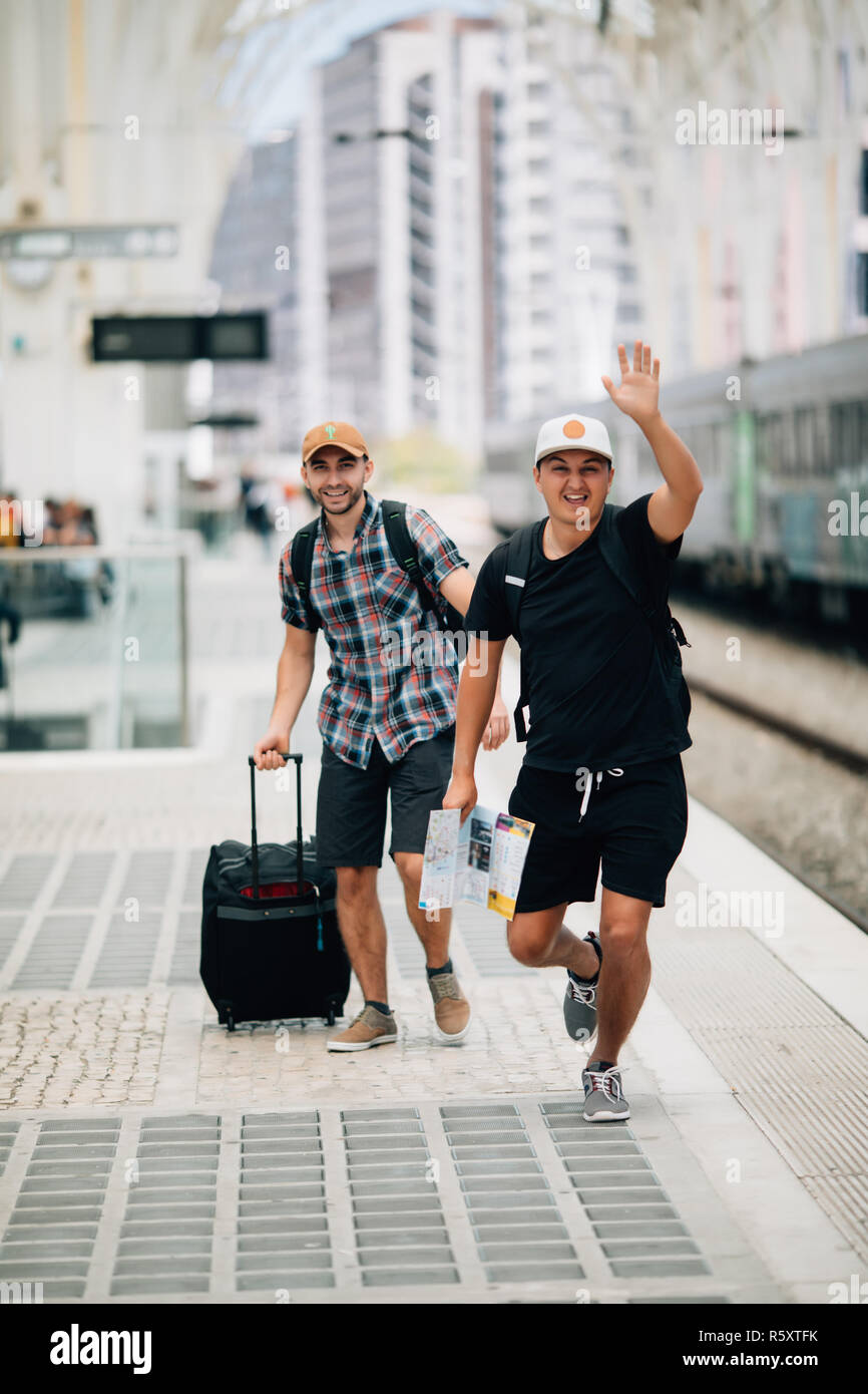 Two man traveler miss train and running after train on platform on ...