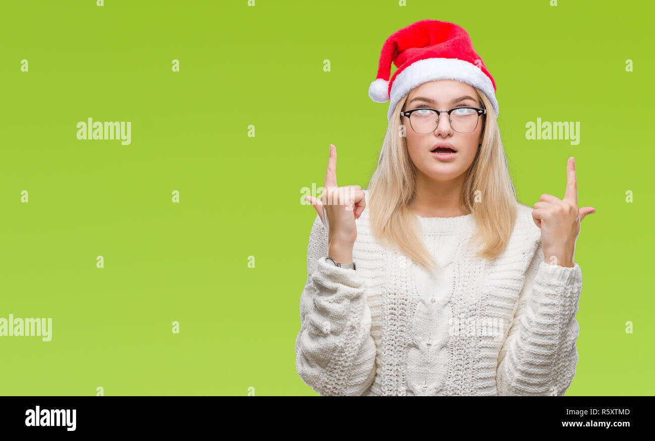 Young caucasian woman wearing christmas hat over isolated background ...