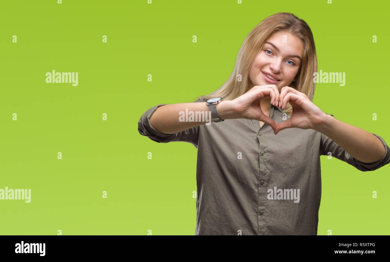 Young caucasian business woman over isolated background smiling in love ...