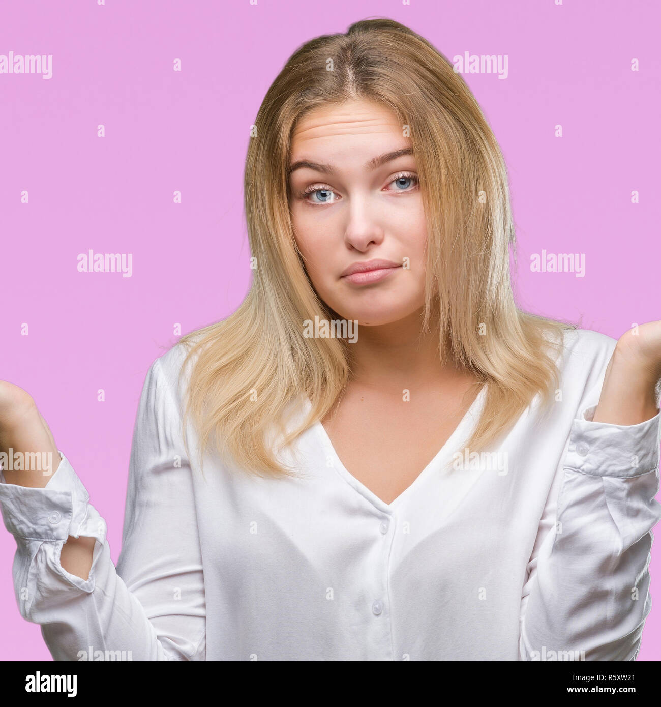 Young caucasian woman over isolated background clueless and confused ...