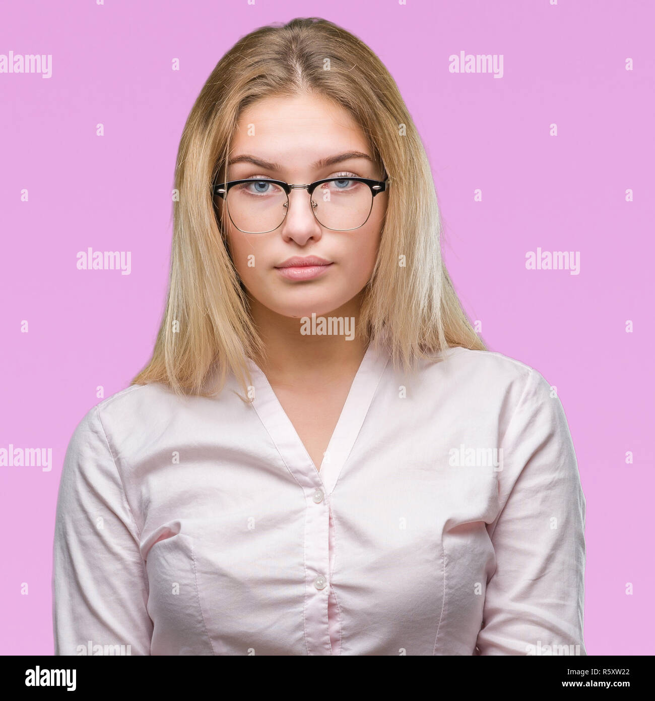 Young caucasian business woman wearing glasses over isolated background ...