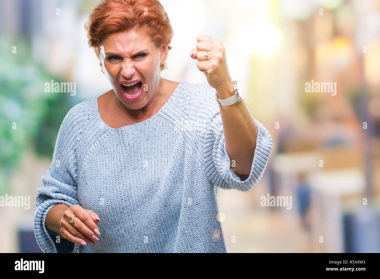 Atrractive senior caucasian redhead woman wearing winter sweater over ...