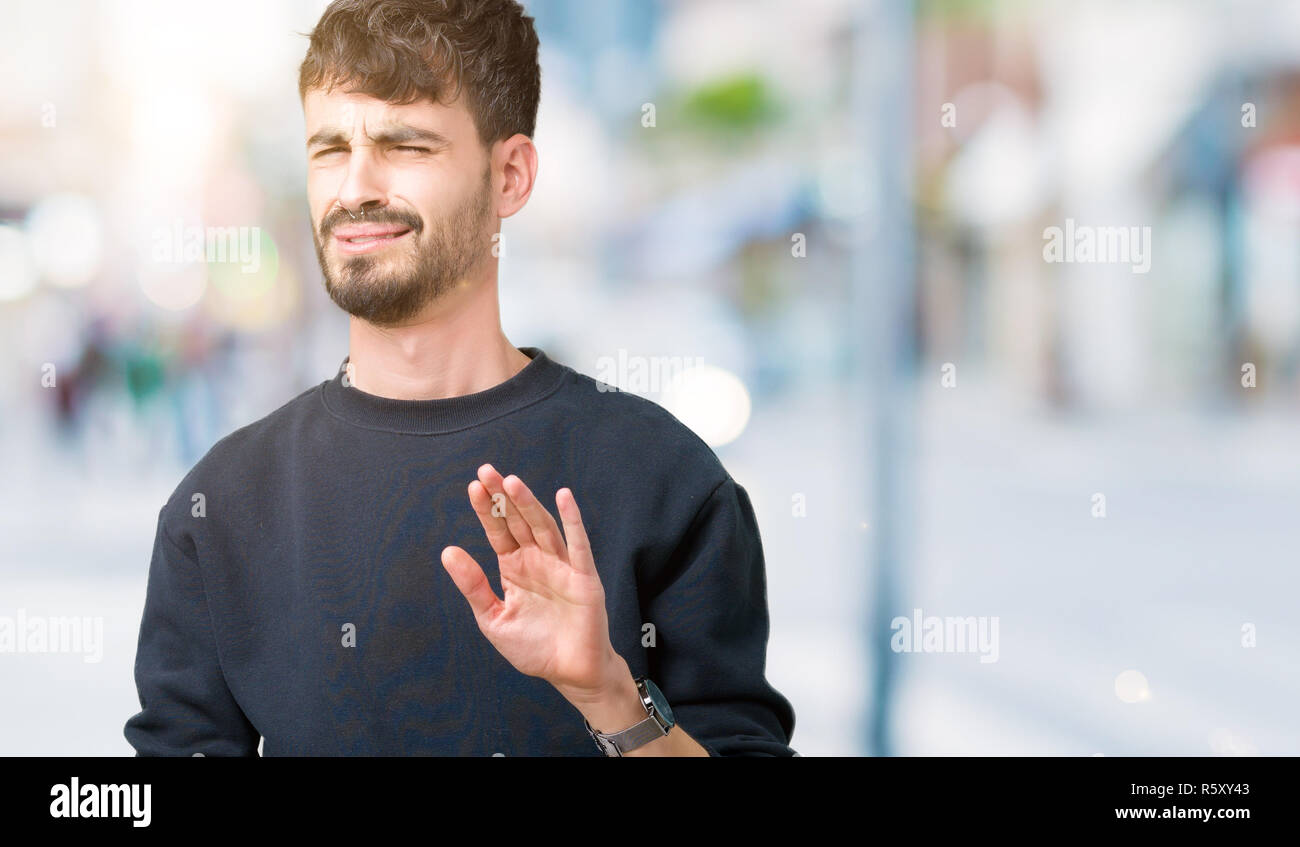 Young handsome man over isolated background disgusted expression ...