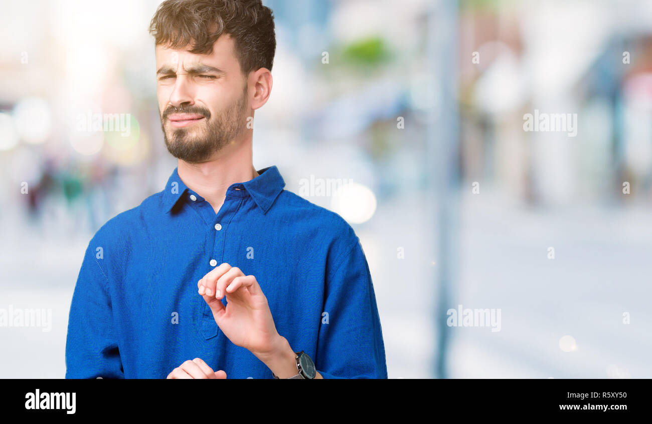 Young handsome man over isolated background disgusted expression ...