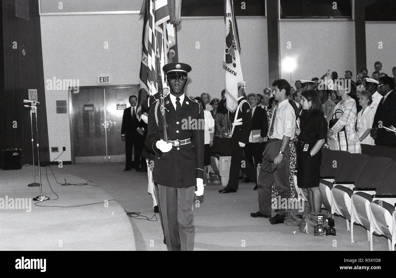 Admin. Atwood presenting general awards - Soldier carrying flag Stock ...