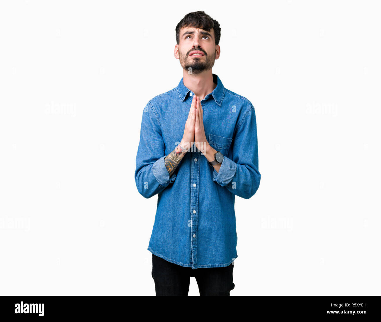 Young handsome man over isolated background begging and praying with ...