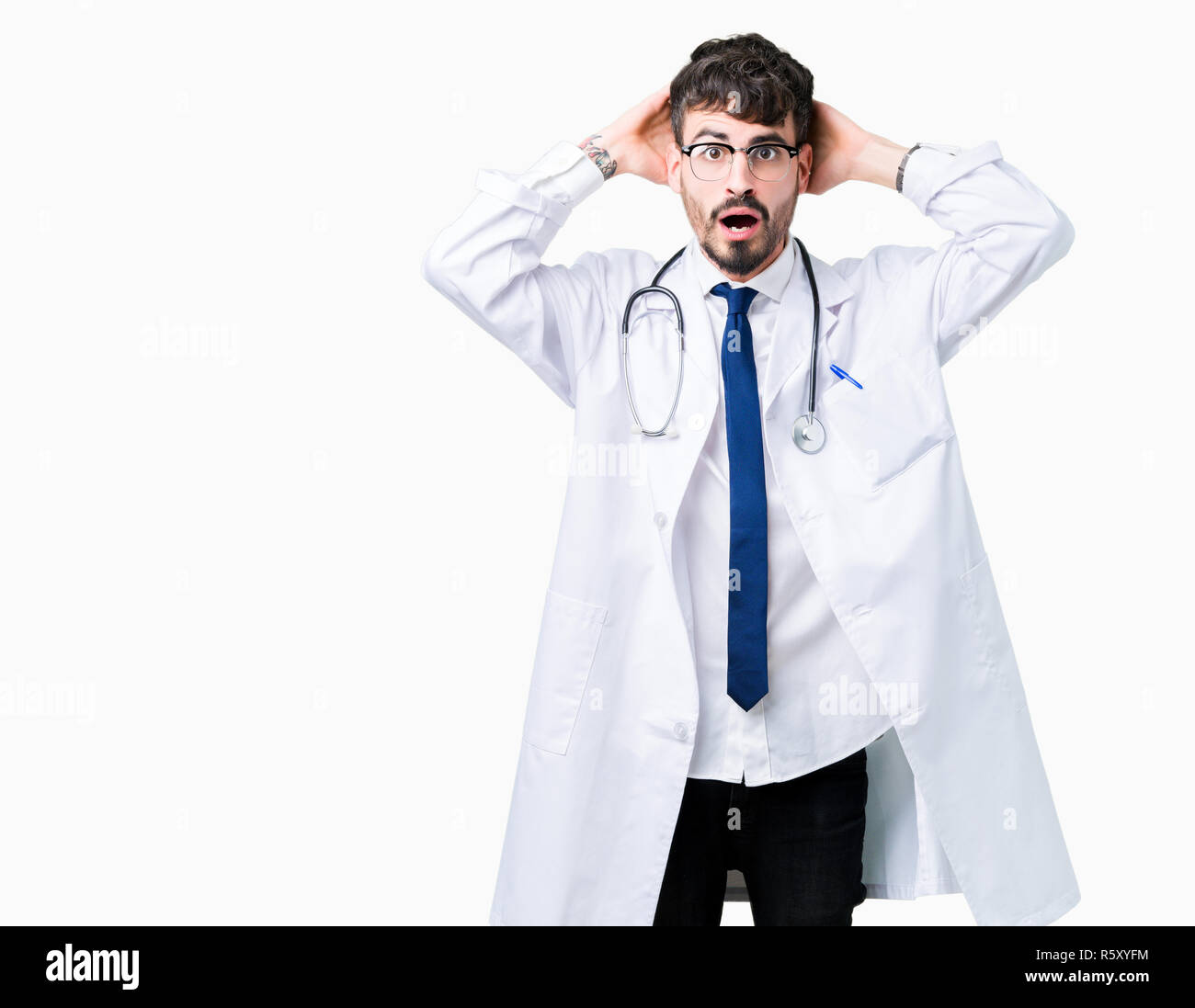 Young doctor man wearing hospital coat over isolated background Crazy ...
