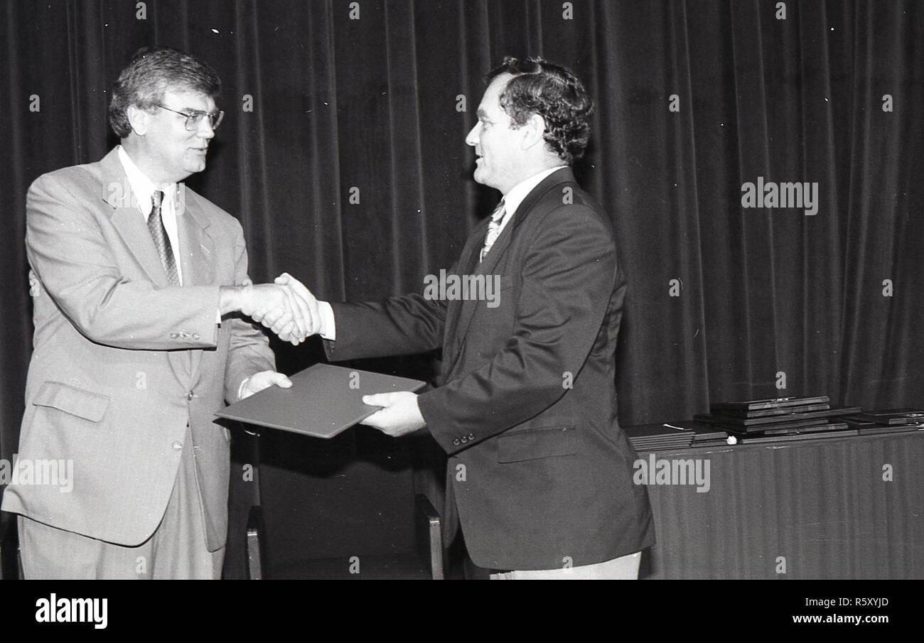 Admin. Atwood presenting general awards - Man receiving award on stage ...