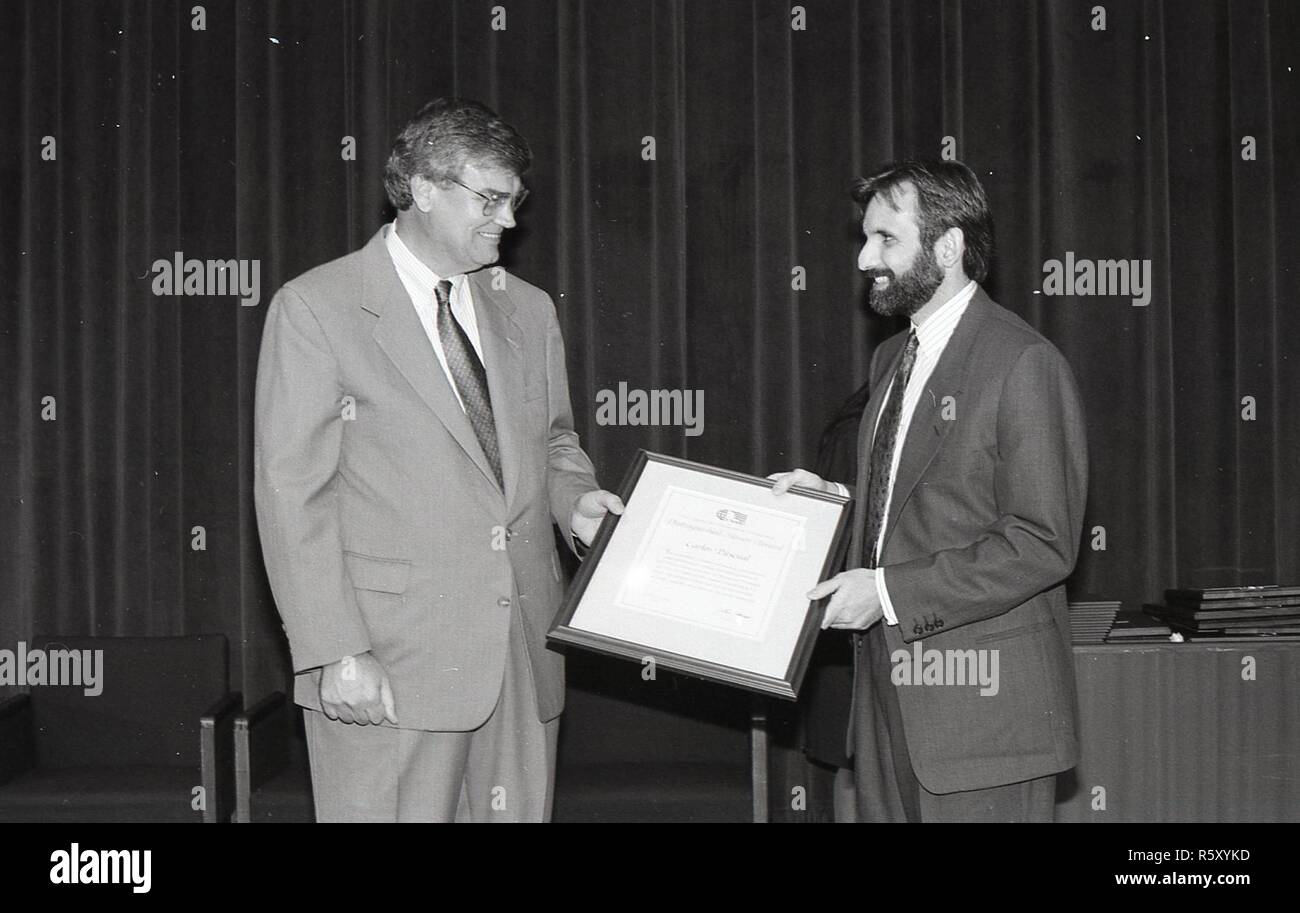 Admin. Atwood presenting general awards - Man receiving award on stage ...