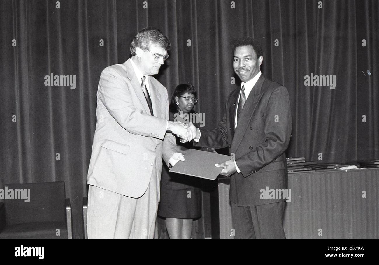 Admin. Atwood presenting general awards - Man receiving award on stage ...