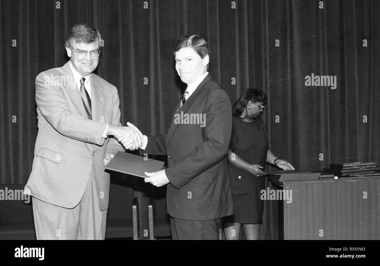 Admin. Atwood presenting general awards - Man receiving award on stage ...