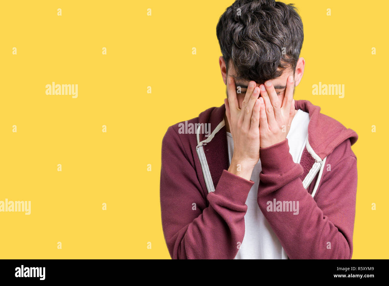 Young handsome man over isolated background with sad expression ...