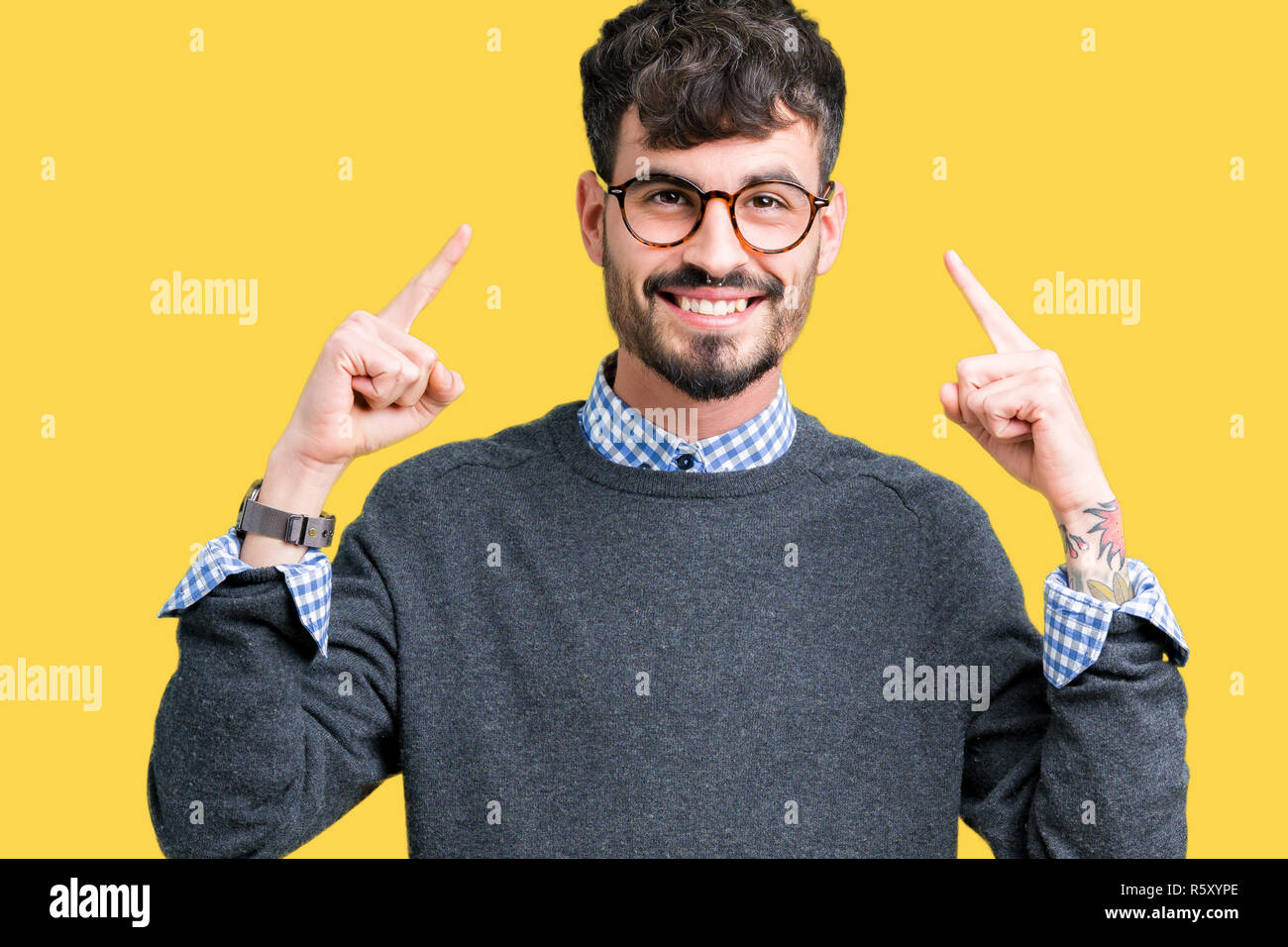 Young handsome smart man wearing glasses over isolated background ...