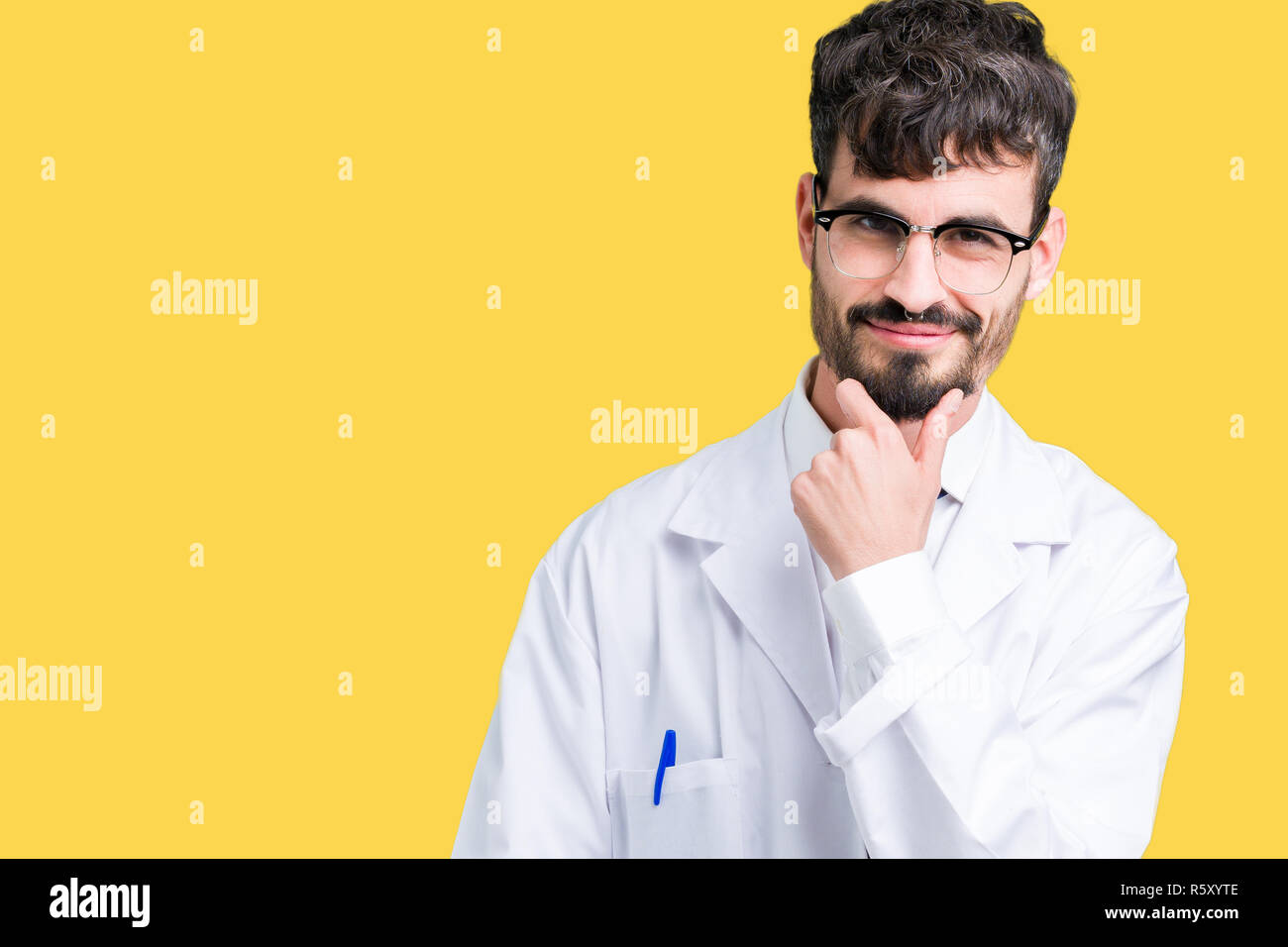 Young professional scientist man wearing white coat over isolated ...