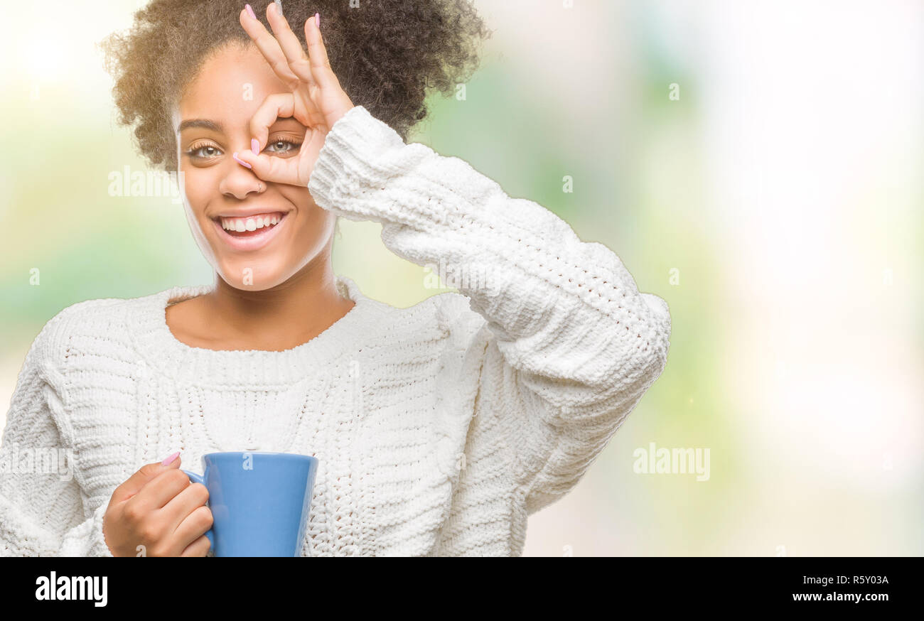 Young afro american woman driking cup of coffee over isolated ...