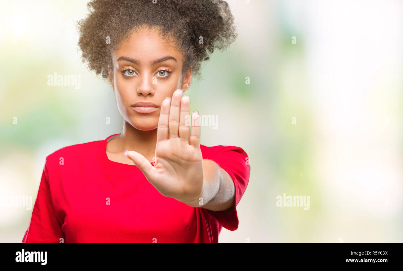 Young afro american woman over isolated background doing stop sing with ...