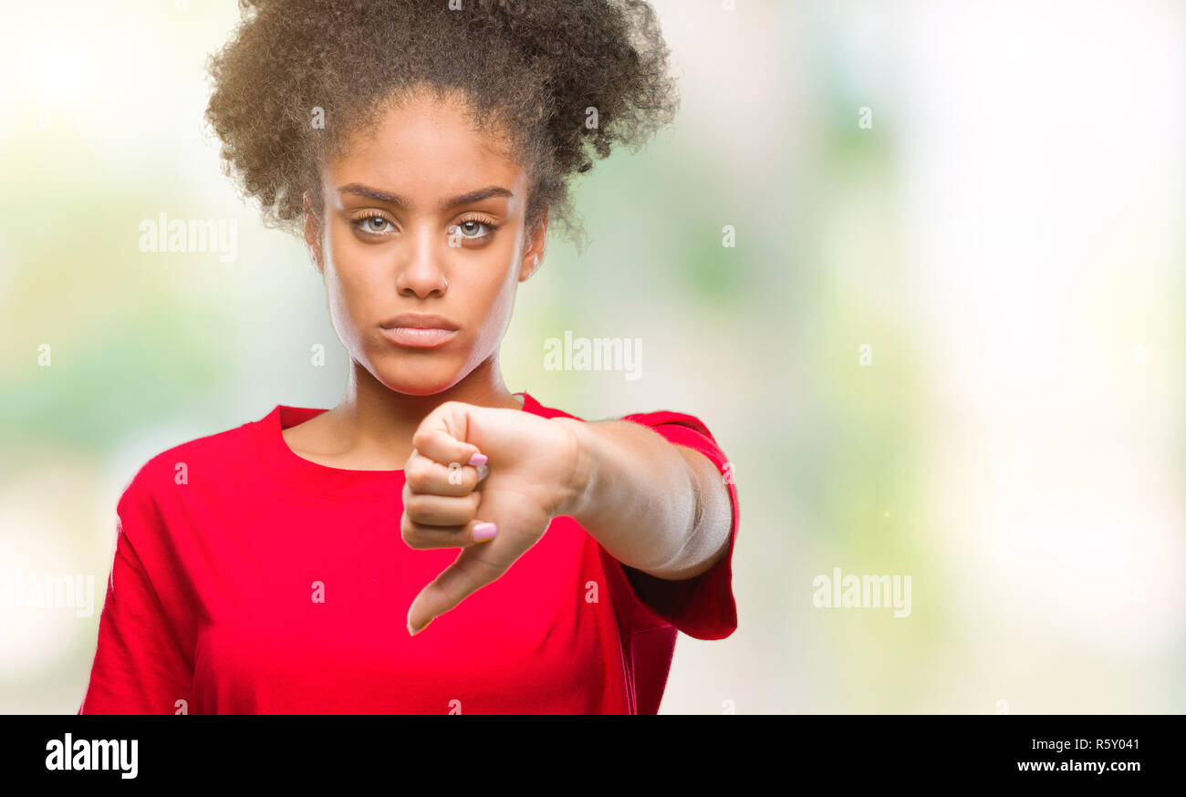 Young afro american woman over isolated background looking unhappy and ...