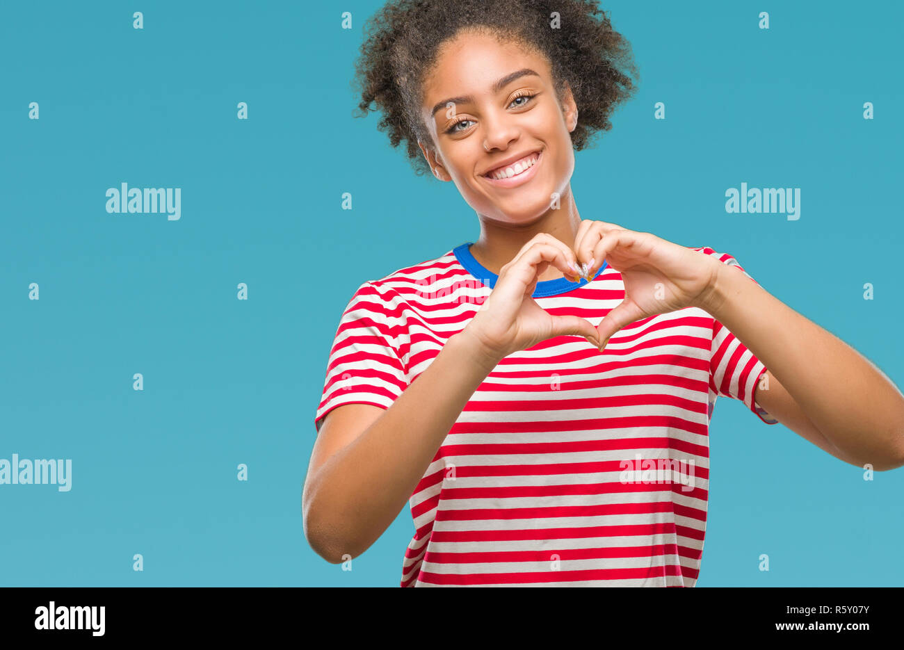 Young afro american woman over isolated background smiling in love ...