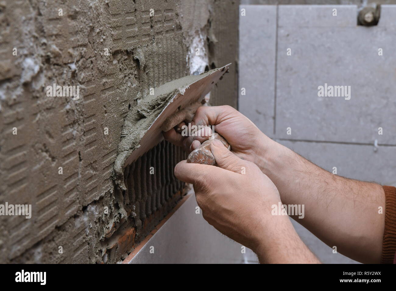 Installing tiles applying mortar wall hi-res stock photography and ...
