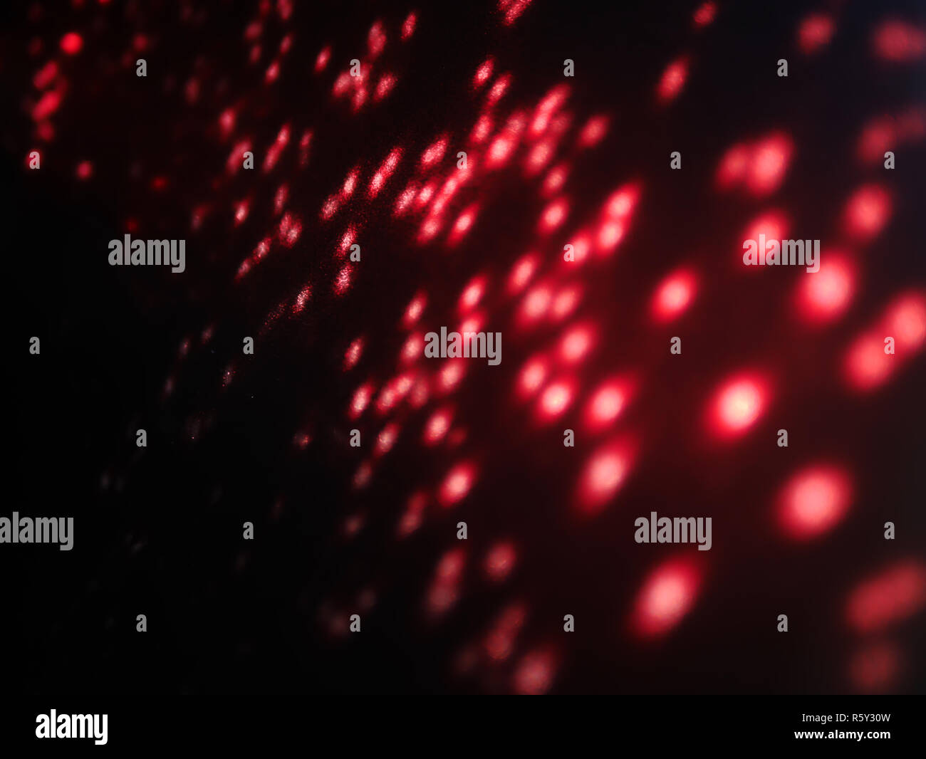 blurred red defocused bright light. lens flare. shiny spots. dark ...