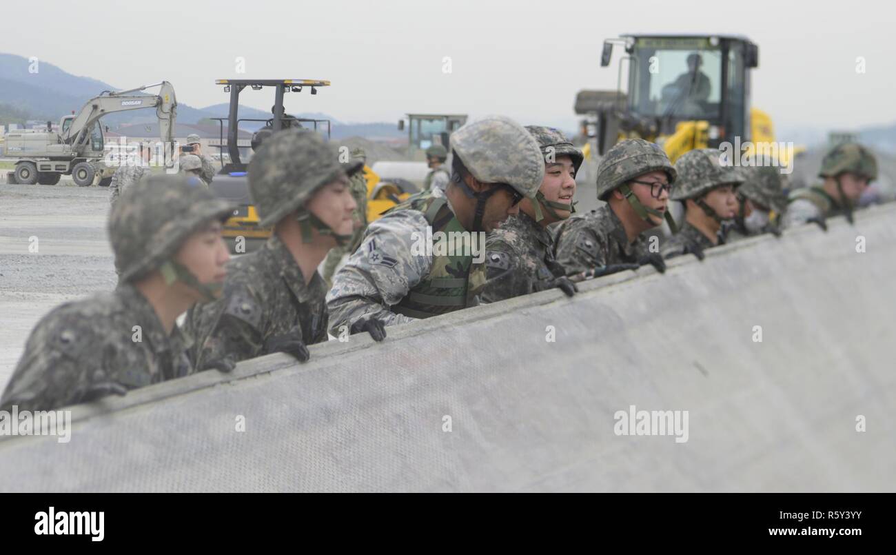 U.S. and Republic of Korea Airmen lift a rapid-runway repair fiberglass ...