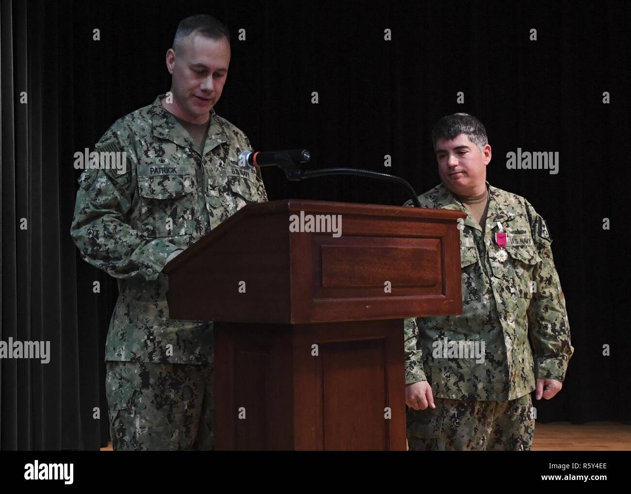 MANAMA, Bahrain (April 20, 2017) Capt. Chase Patrick, left, reads his ...