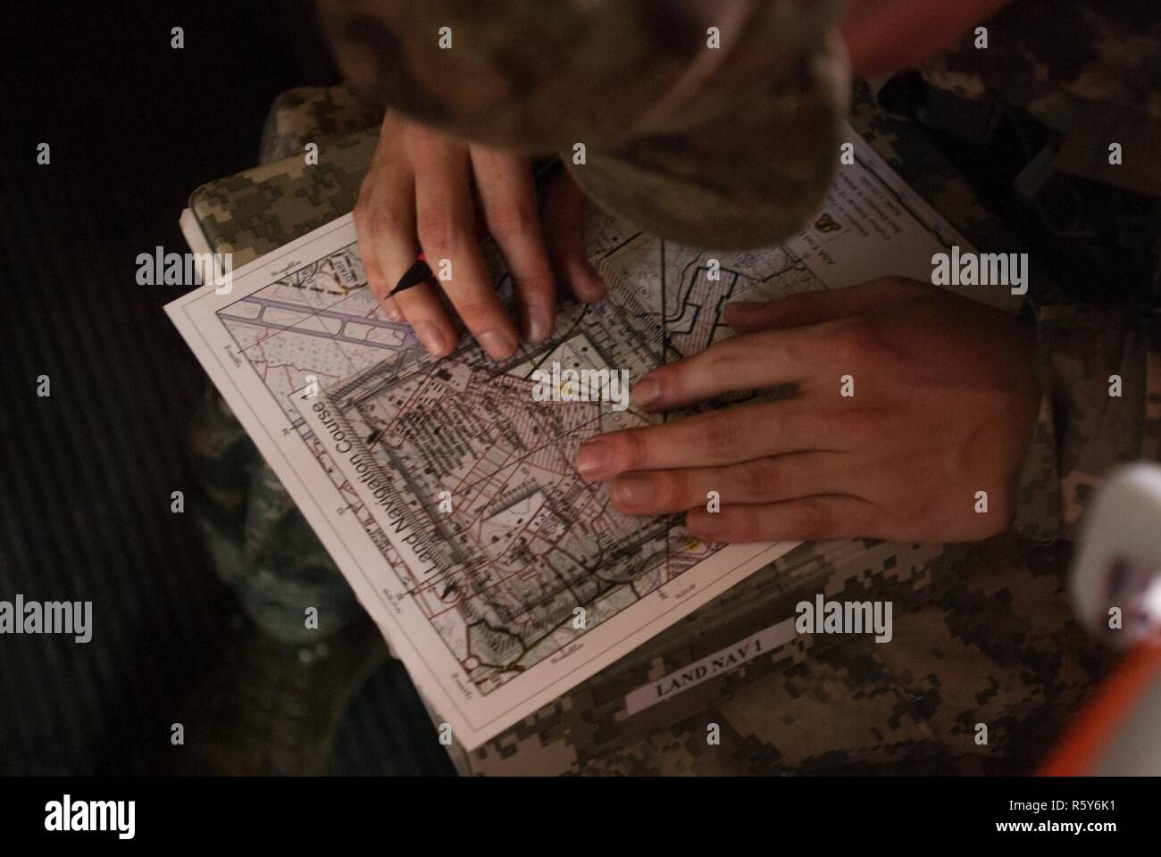 A soldier plots his navigation points on a base map at the Combined ...